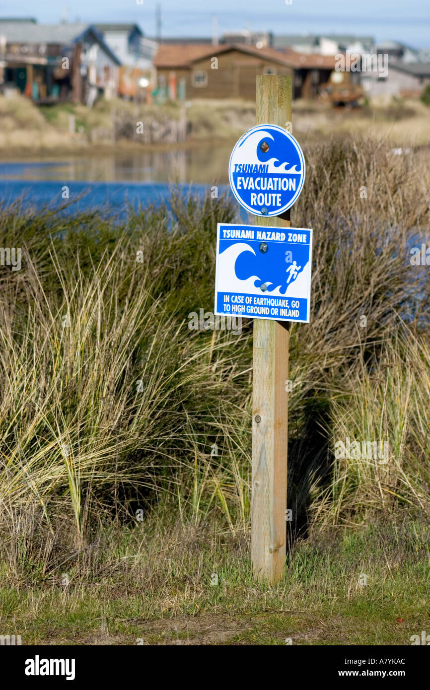 Tsunami evacuation route sign with houses in the background in Waldport ...