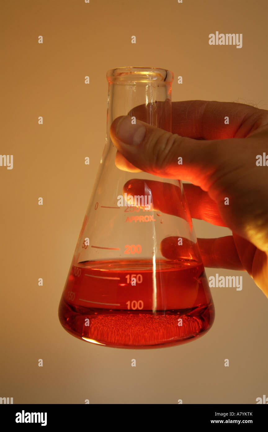 Flask containing orange solution Stock Photo - Alamy