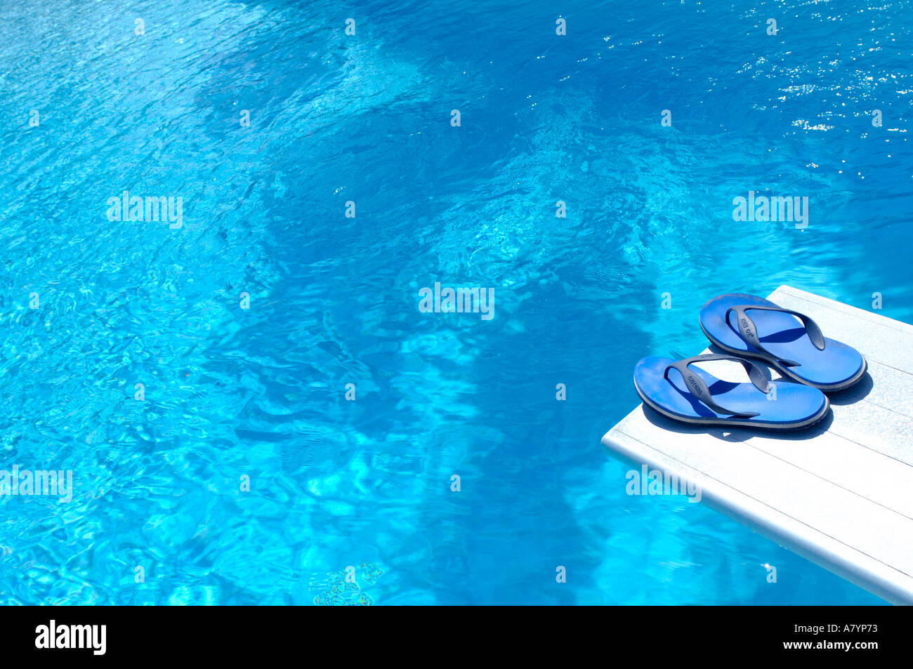 sandals on pool diving board Stock Photo - Alamy