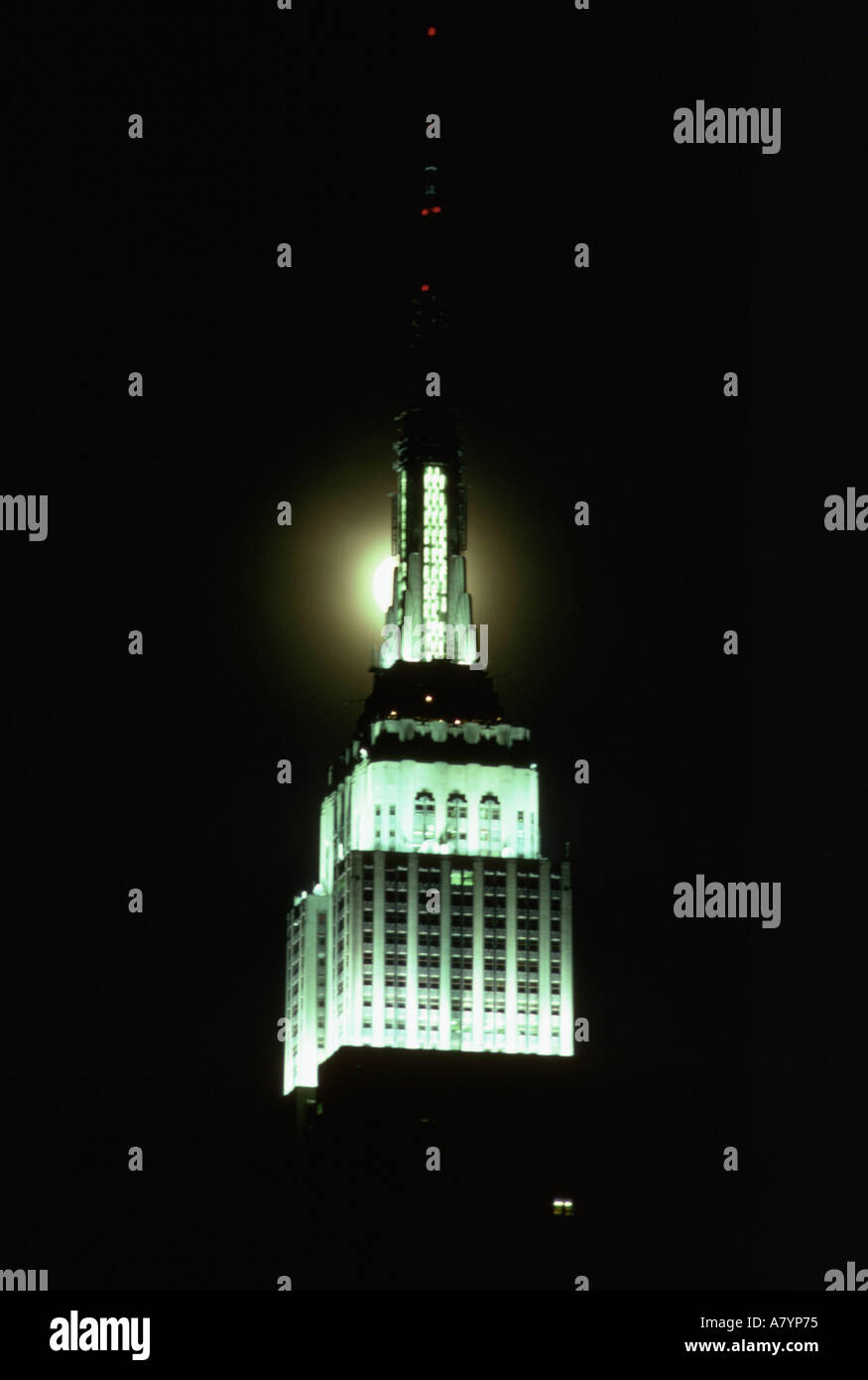Empire State building with full moon in background Stock Photo - Alamy