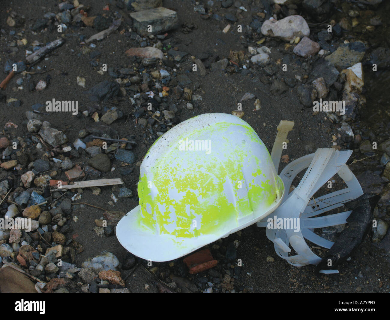 Broken construction workers hard hat lying in dirt Stock Photo - Alamy