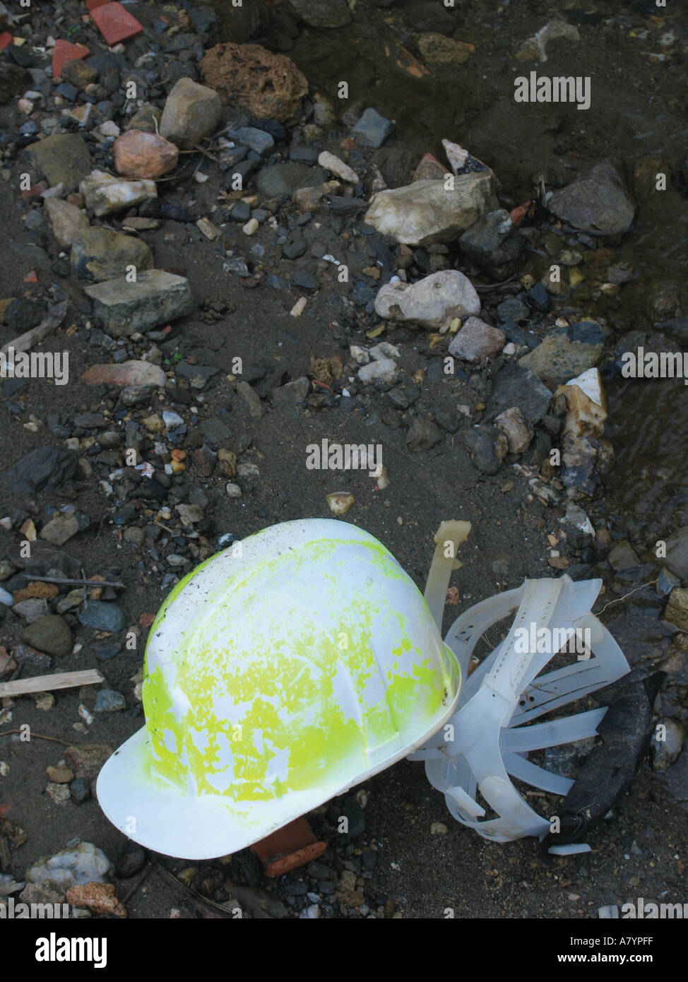 Broken construction workers hard hat lying in dirt Stock Photo - Alamy