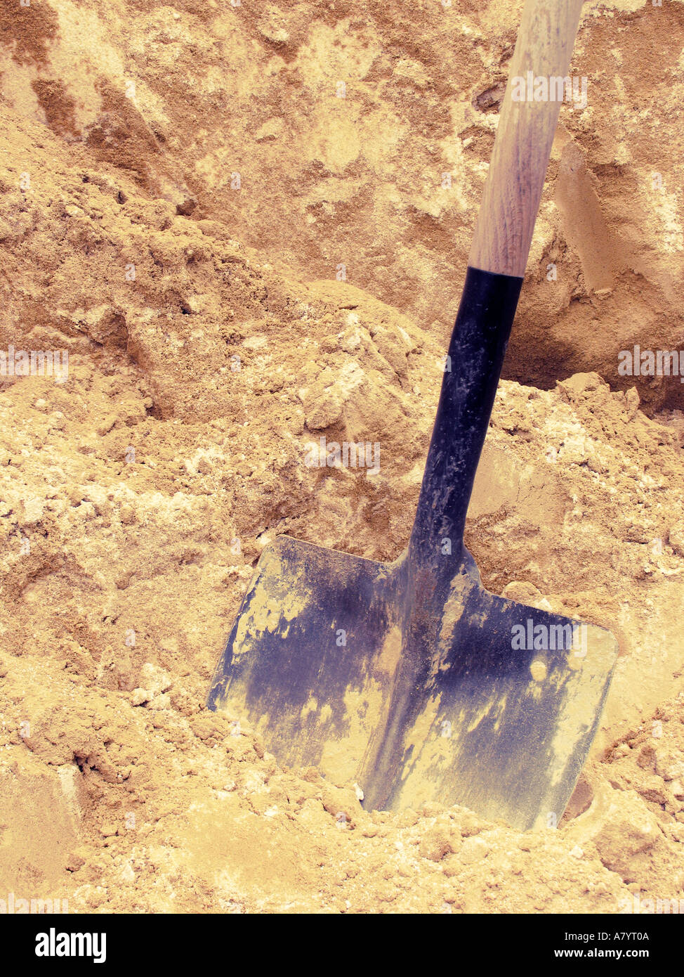 Shovel in sand pile Stock Photo - Alamy
