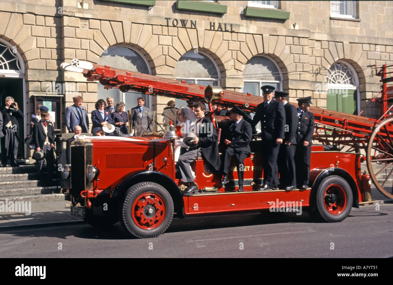 Glastonbury wedding guests on and around restored old fashioned fire ...
