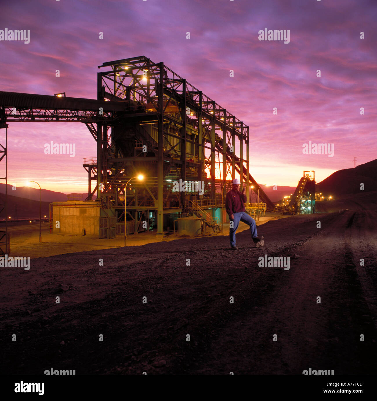 Conveyor belt carrying copper ore into crusher before processing during ...