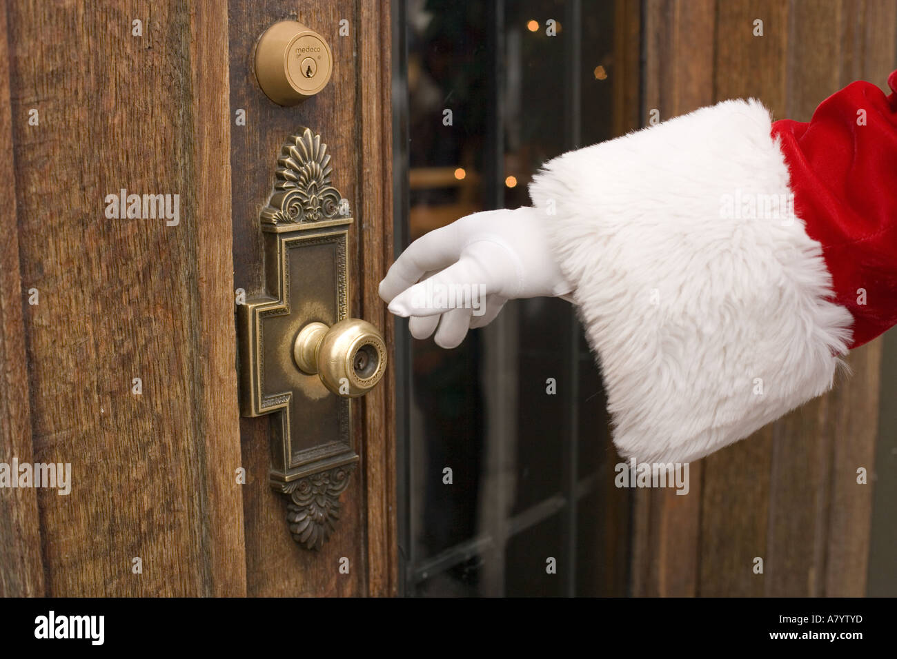 Santa Claus opens a heavy wooden door Stock Photo - Alamy