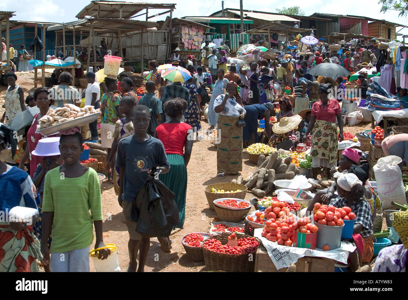 Traditional West African open air food market with market traders ...