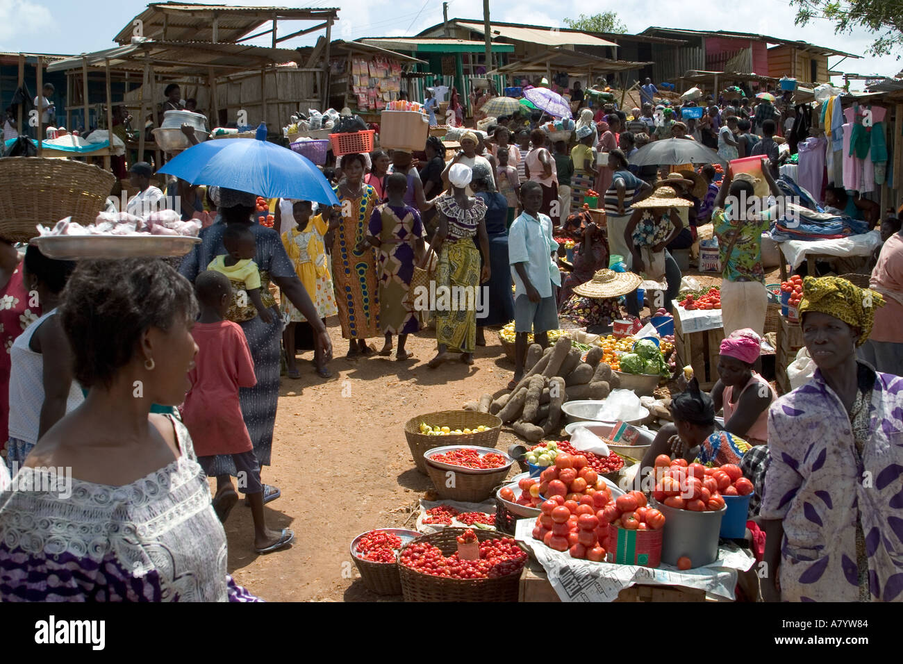 Traditional West African open air food market with market traders ...
