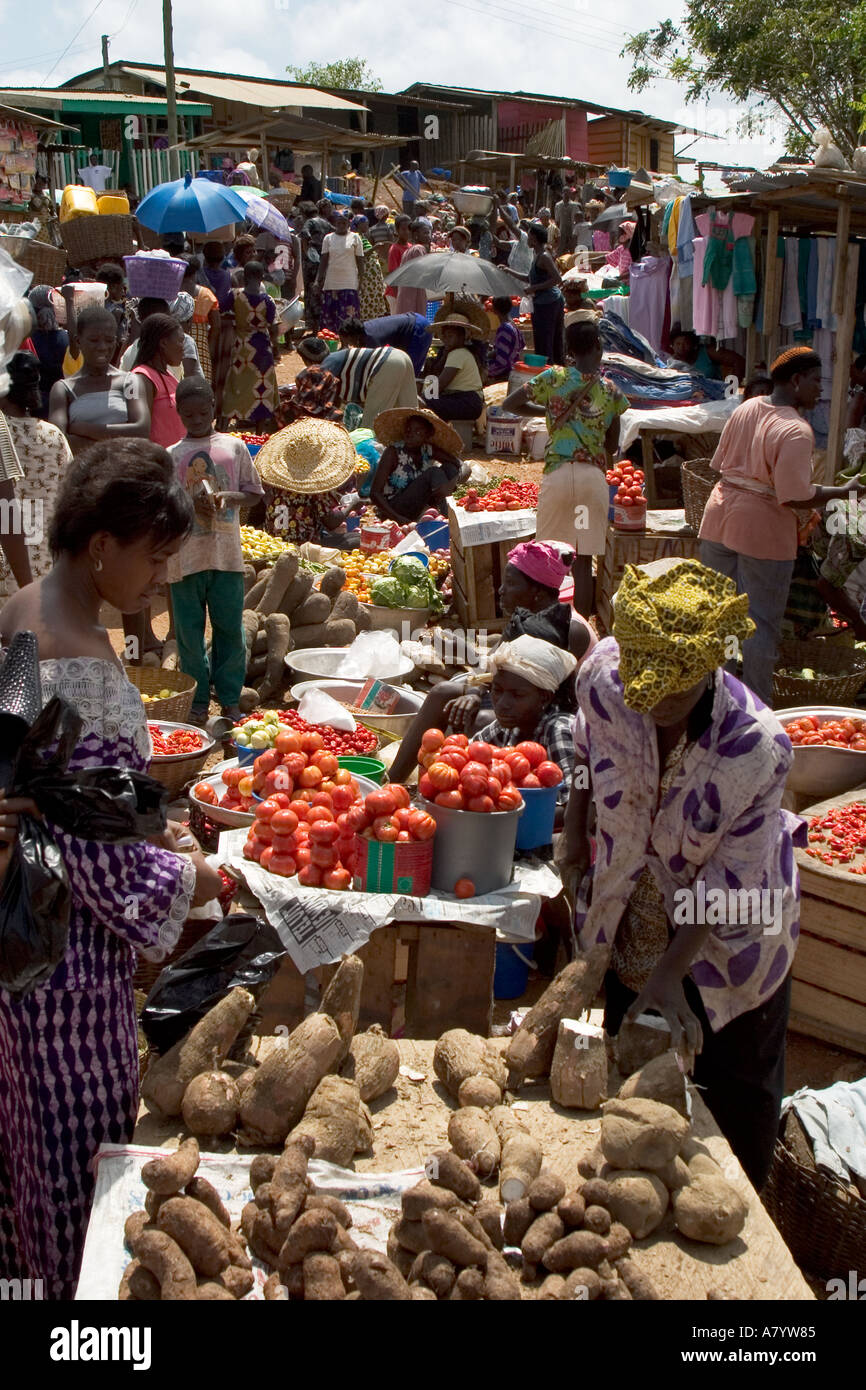 Traditional West African open air food market with market traders ...