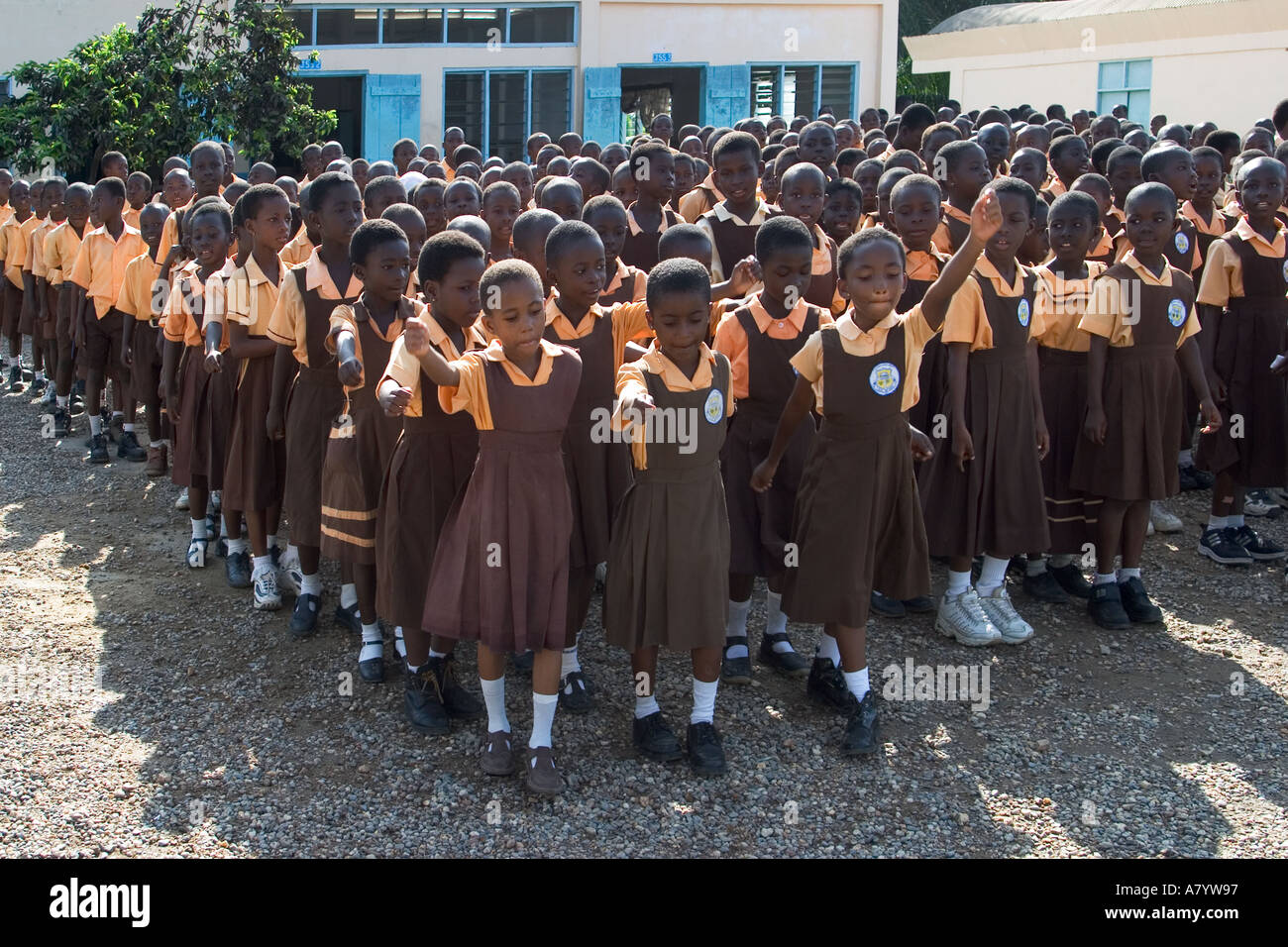 Mixed group of school children, mostly juniors, marching into assembly ...