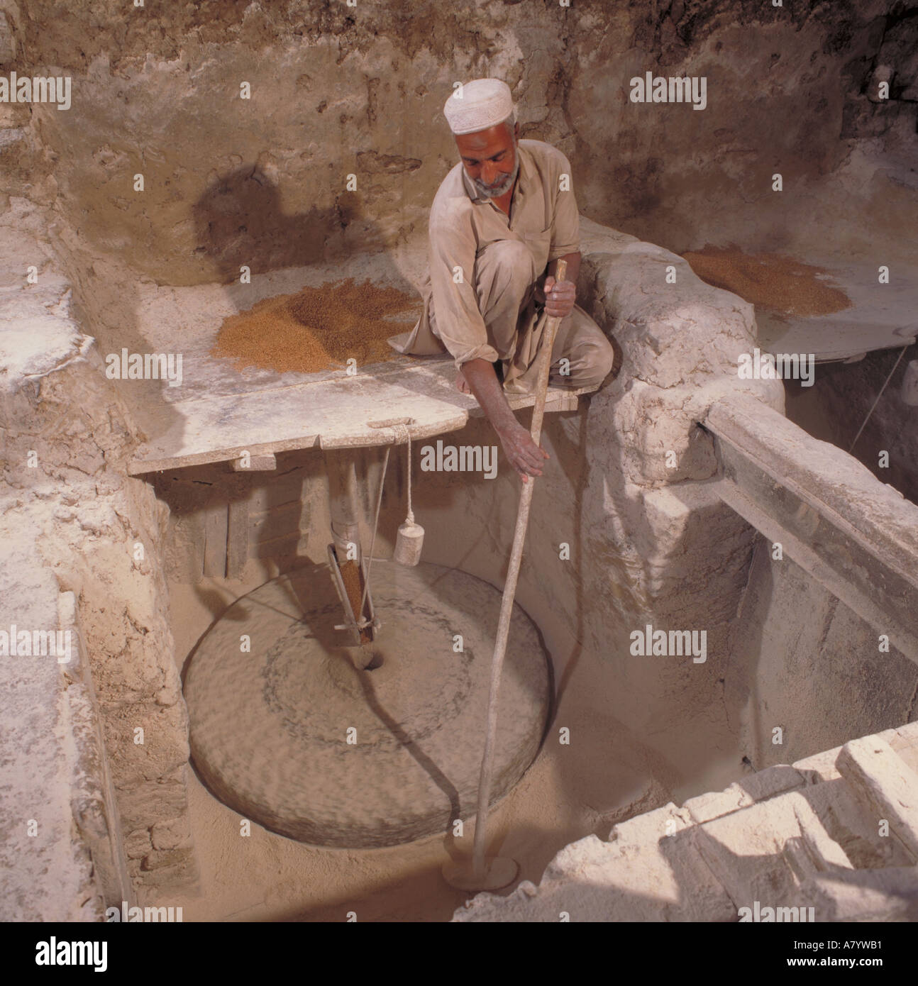 Miller grinding maize for flour inside mill by Swat Canal, Swabi Valley ...