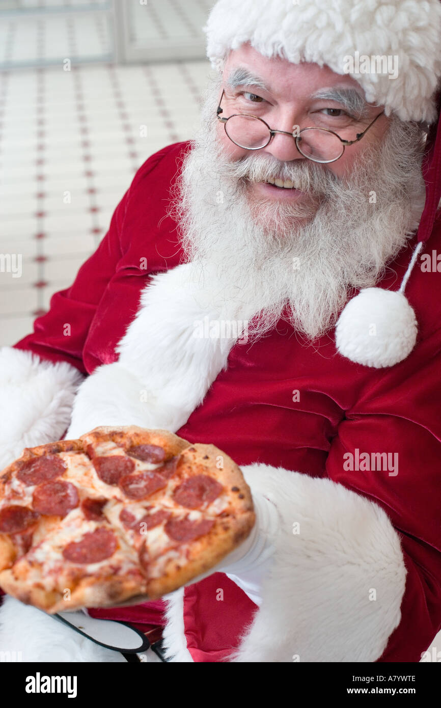 Santa Claus eating pizza Stock Photo - Alamy