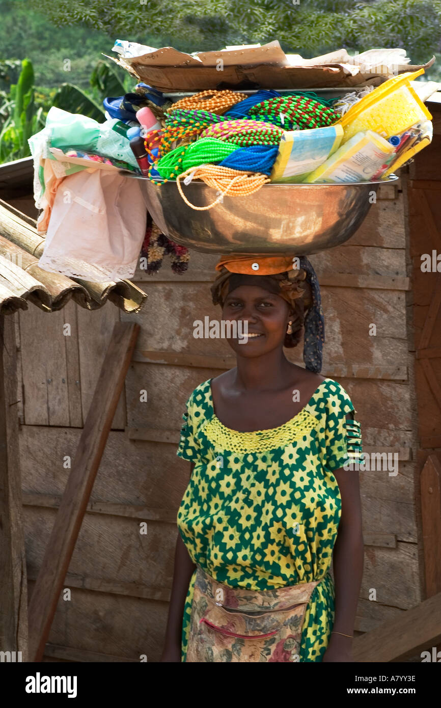 Pretty West African street hawker selling goods from bowl carried on ...