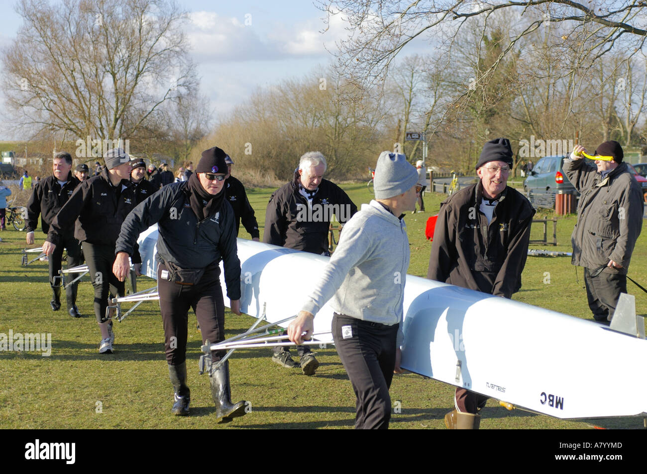 the Molesey boat club senior mens octuple team carrying their boat at ...