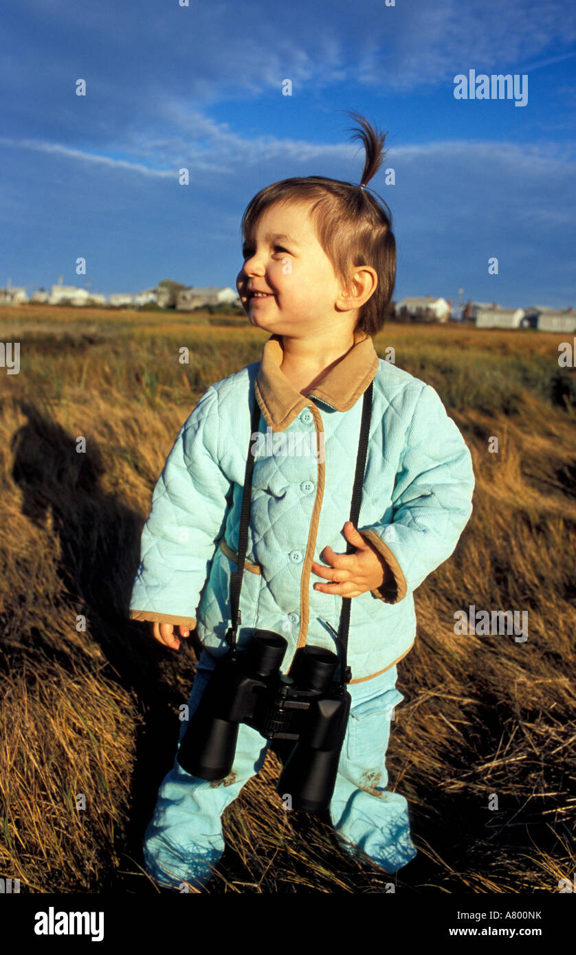 Biddeford, ME. A budding young naturalist explores a salt marsh near ...