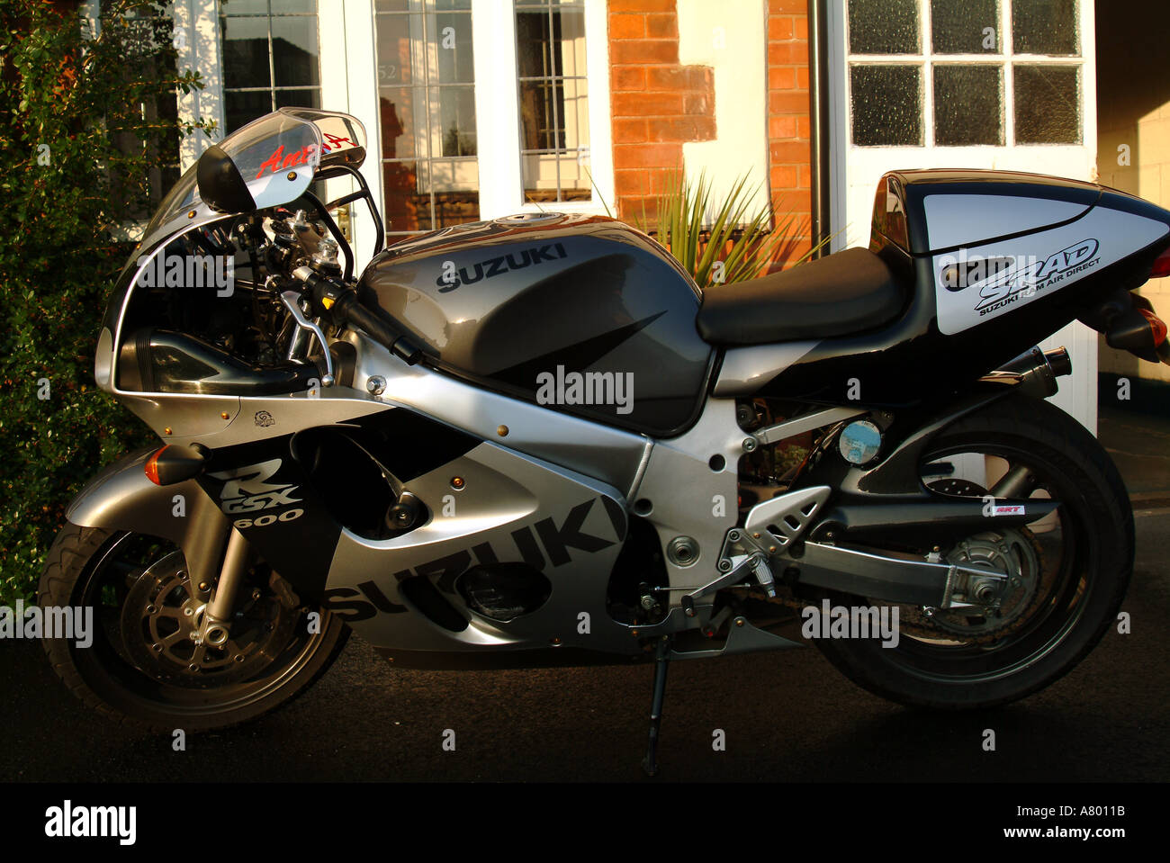 suzuki motorcycle parked outside detached house Stock Photo - Alamy