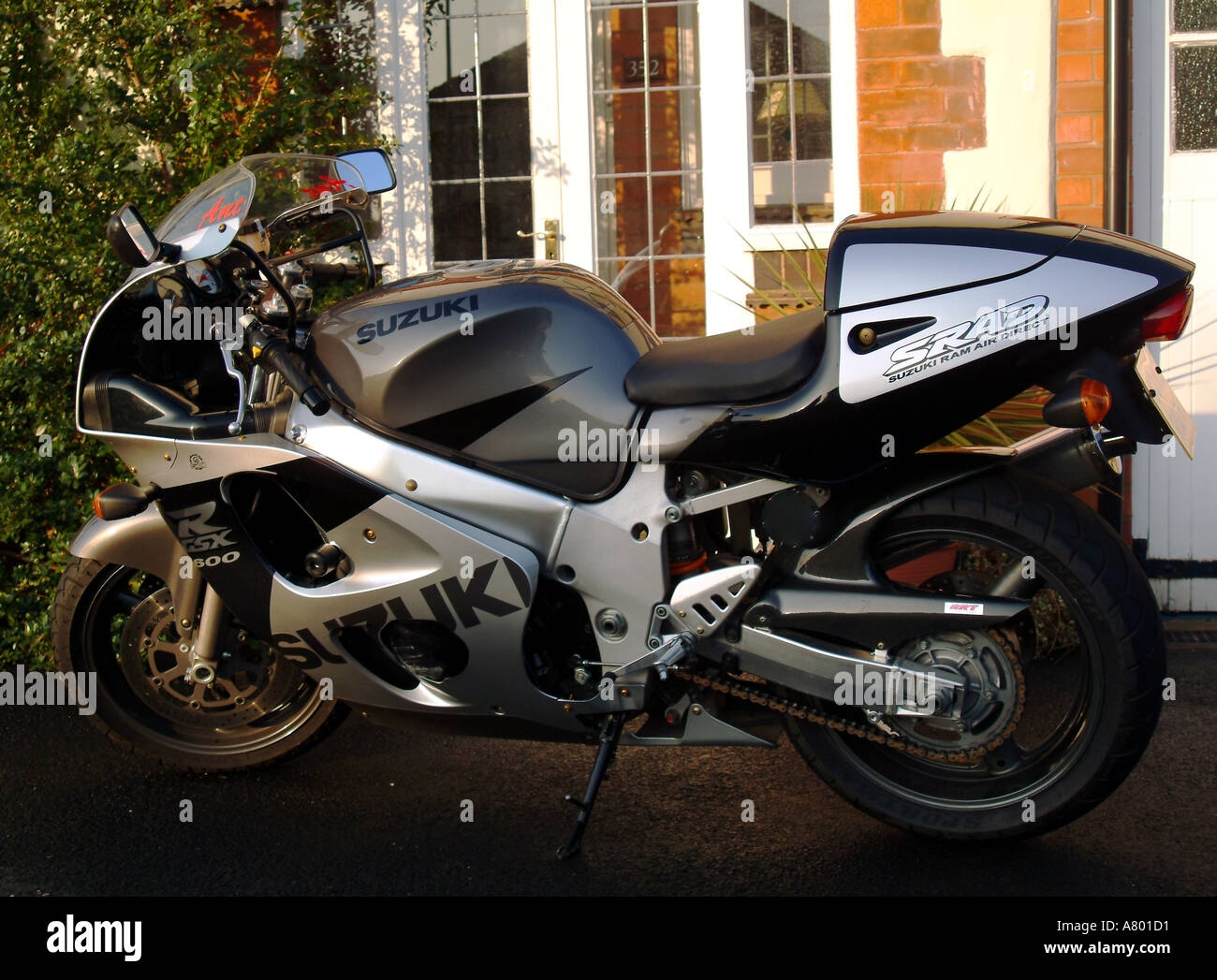 suzuki motorcycle parked outside detached house Stock Photo - Alamy