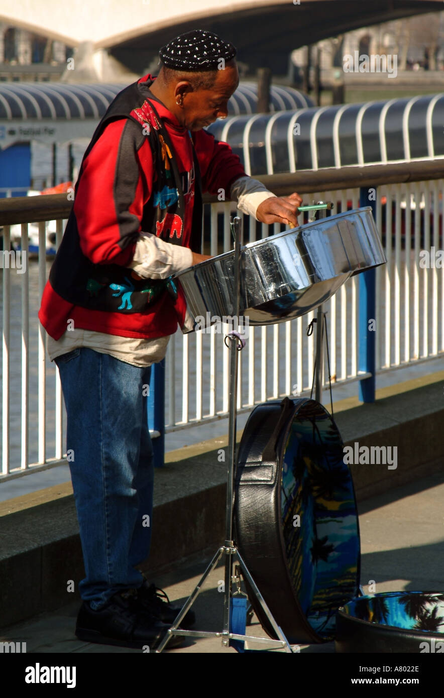 london river thames south bank steel pan player Stock Photo - Alamy