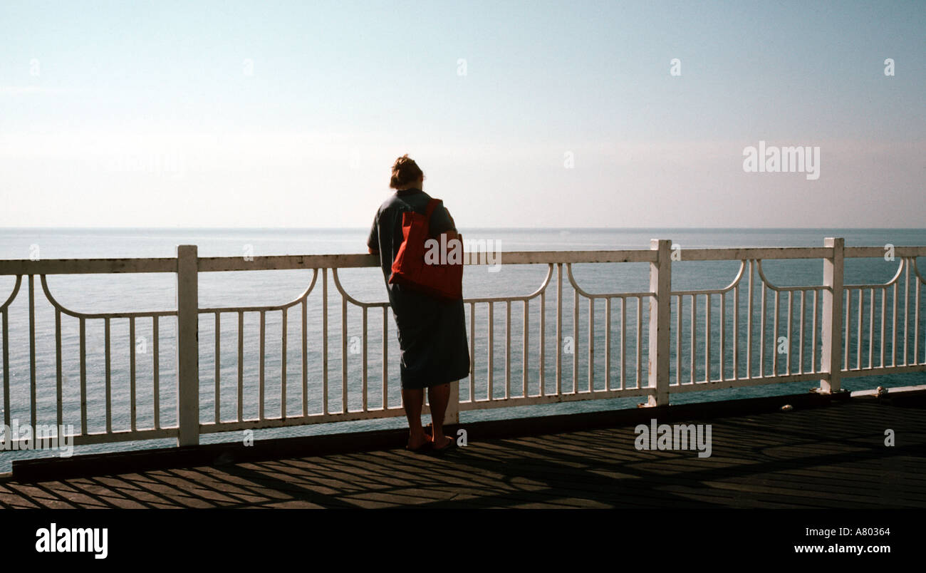 Lone figure looking out to sea hi-res stock photography and images - Alamy
