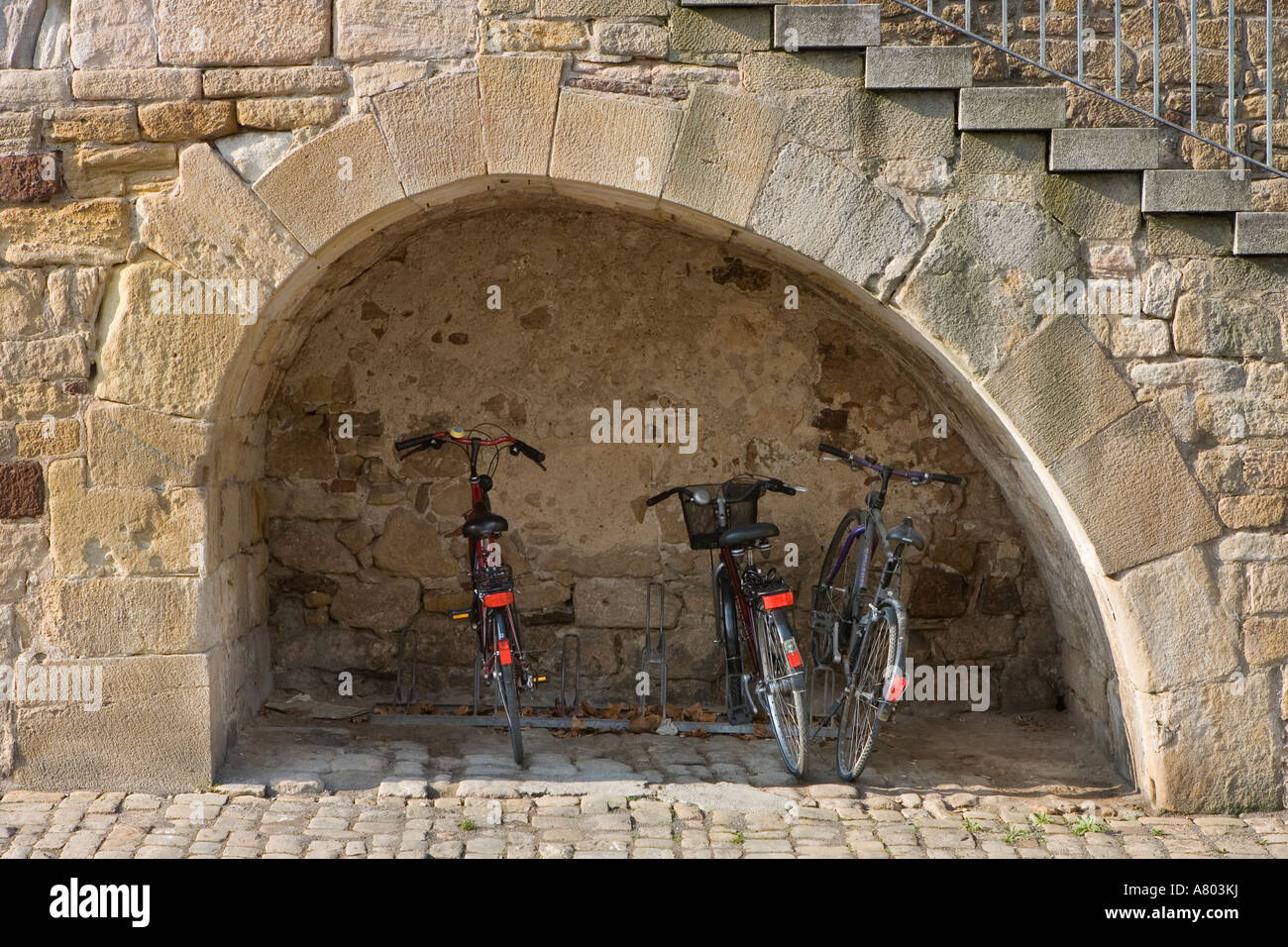 Bicycles stored under an archway in the old university town of ...