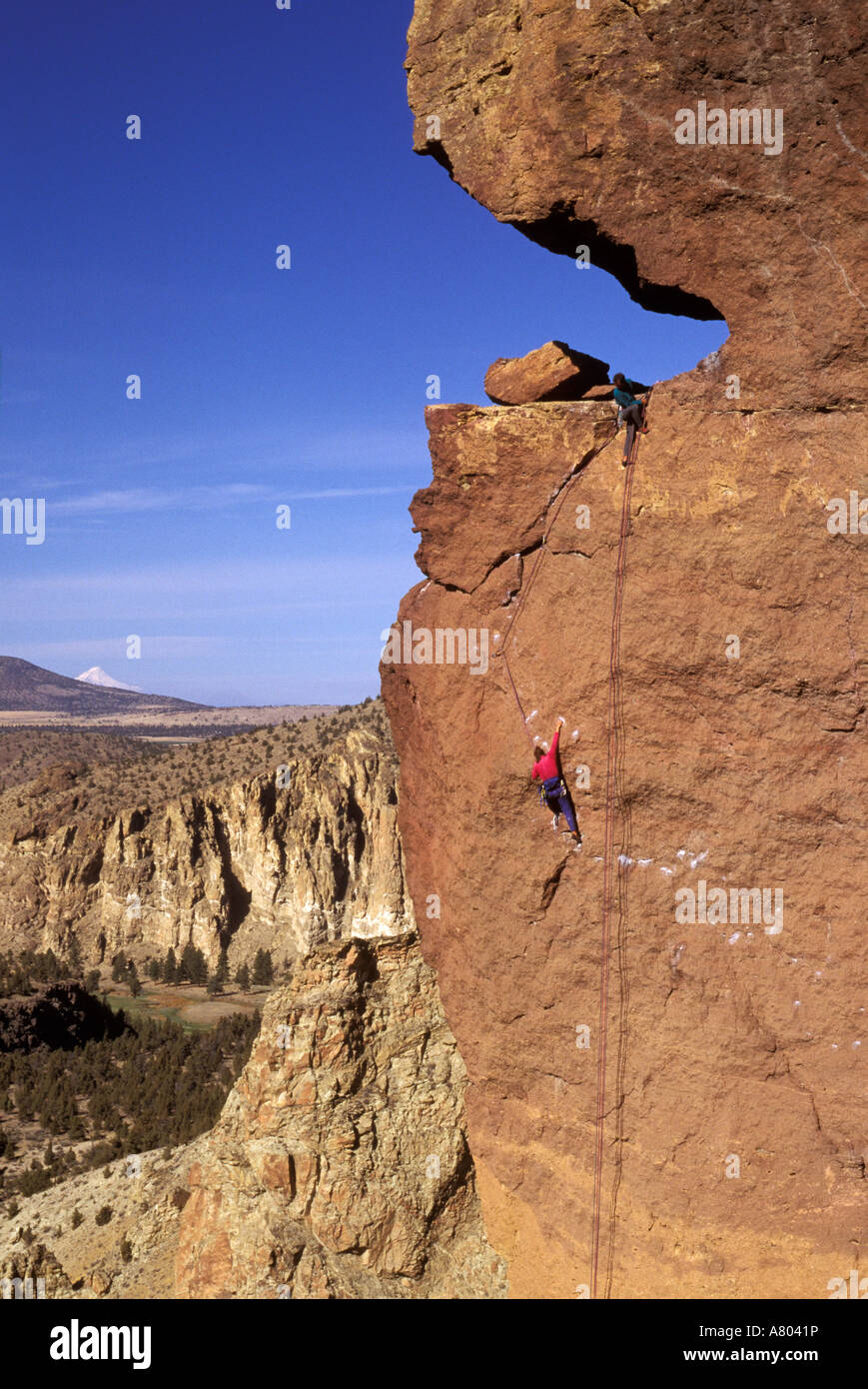 Two climbers make their way up the sheer Monkey Face, in Smith Rock ...