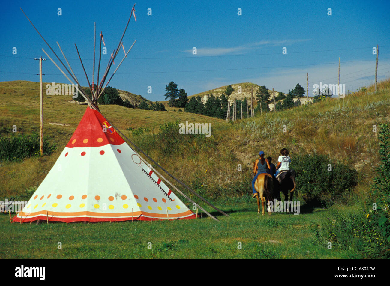 Riding horses near tipi, Pine Ridge Indian Reservation, South Dakota ...