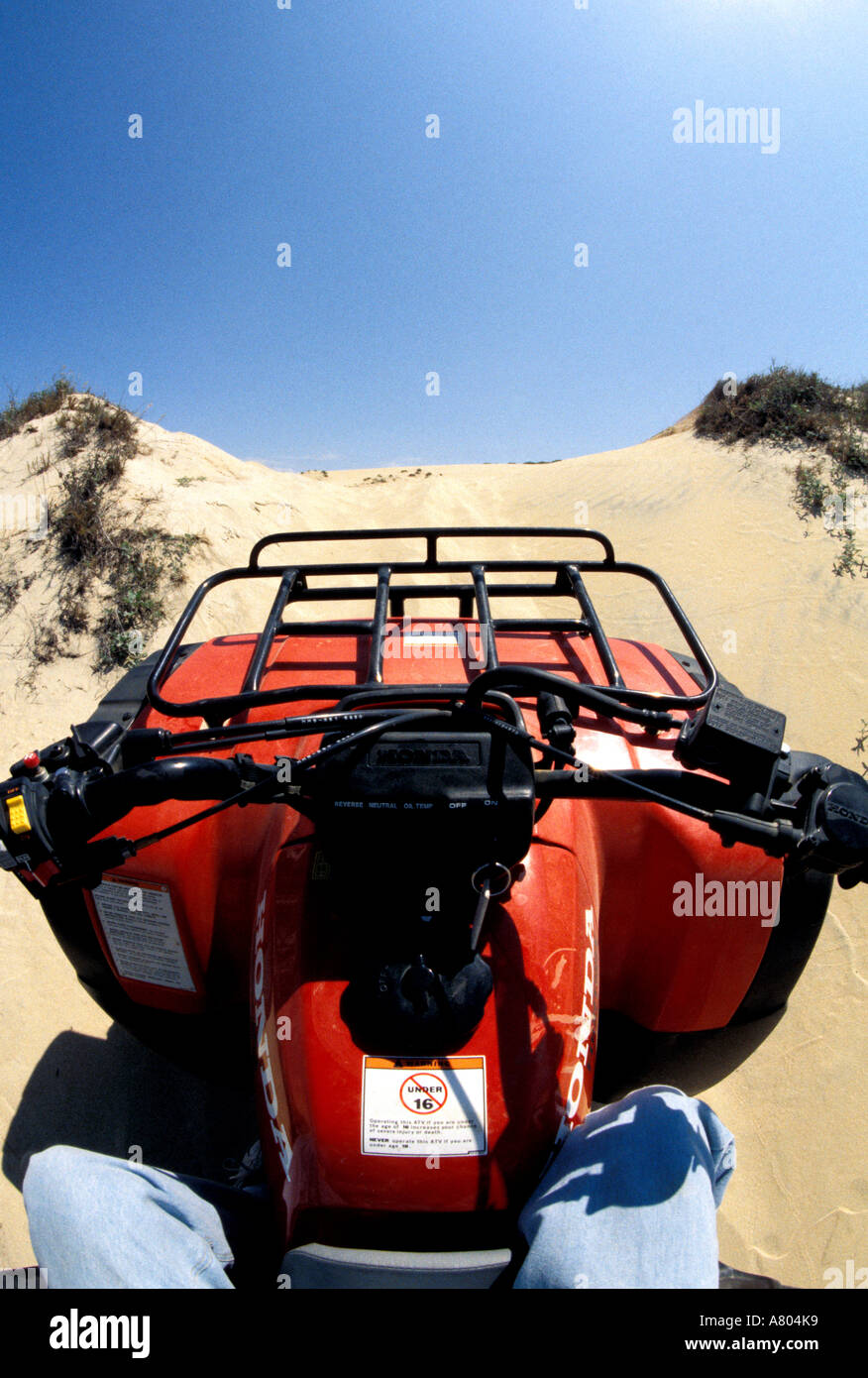 Dune buggy in desert climbing hill ATV all terrain vehicle Stock Photo ...