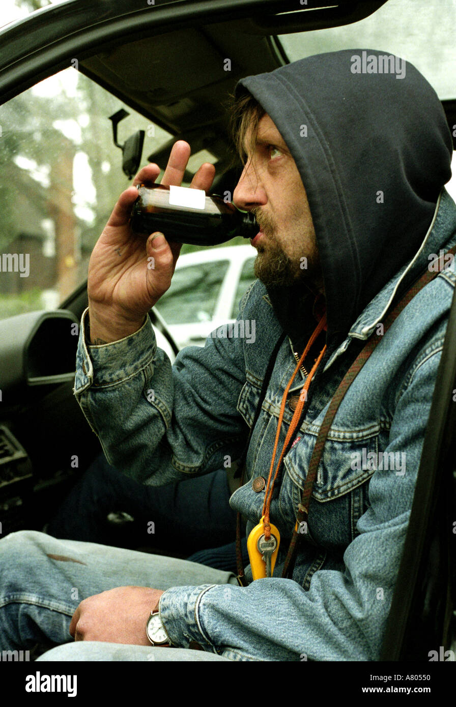 Heroin addict sitting in the car taking his prescription Methodone ...