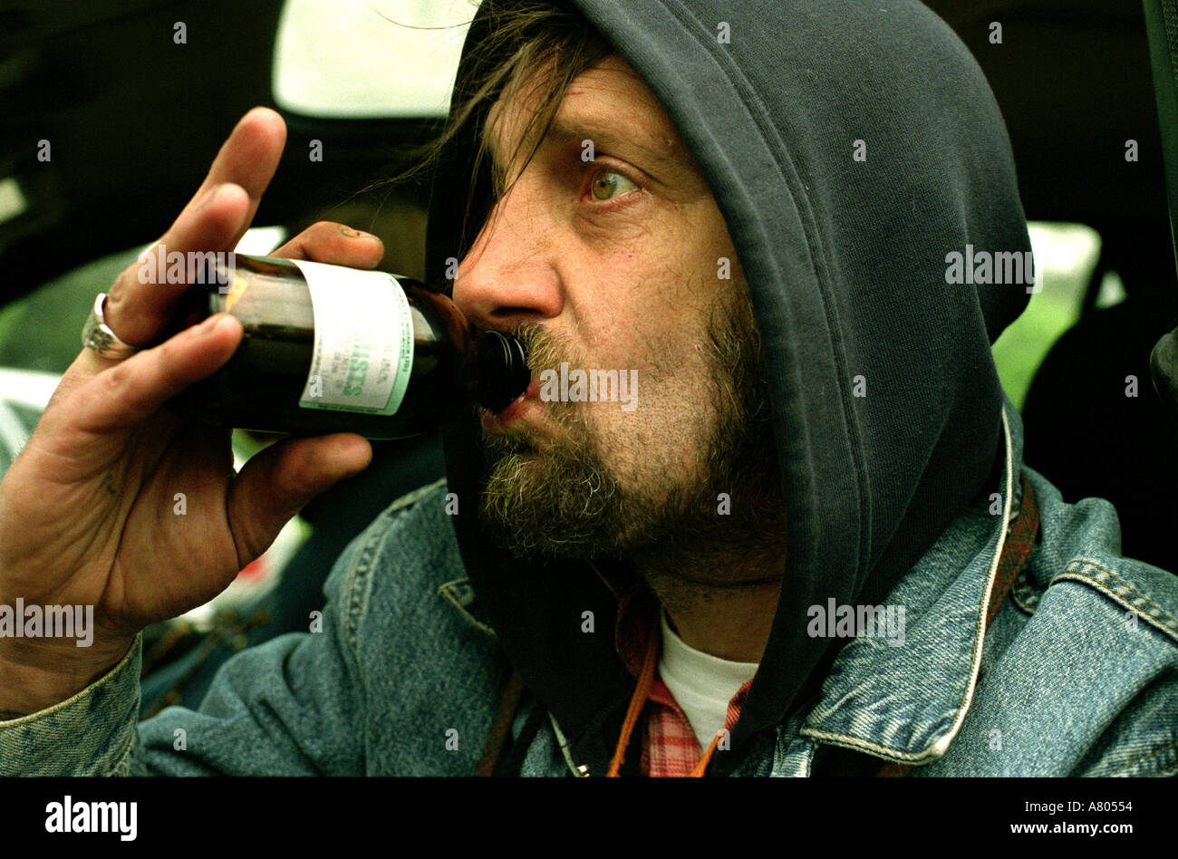 Heroin addict sitting in the car taking his prescription Methodone ...