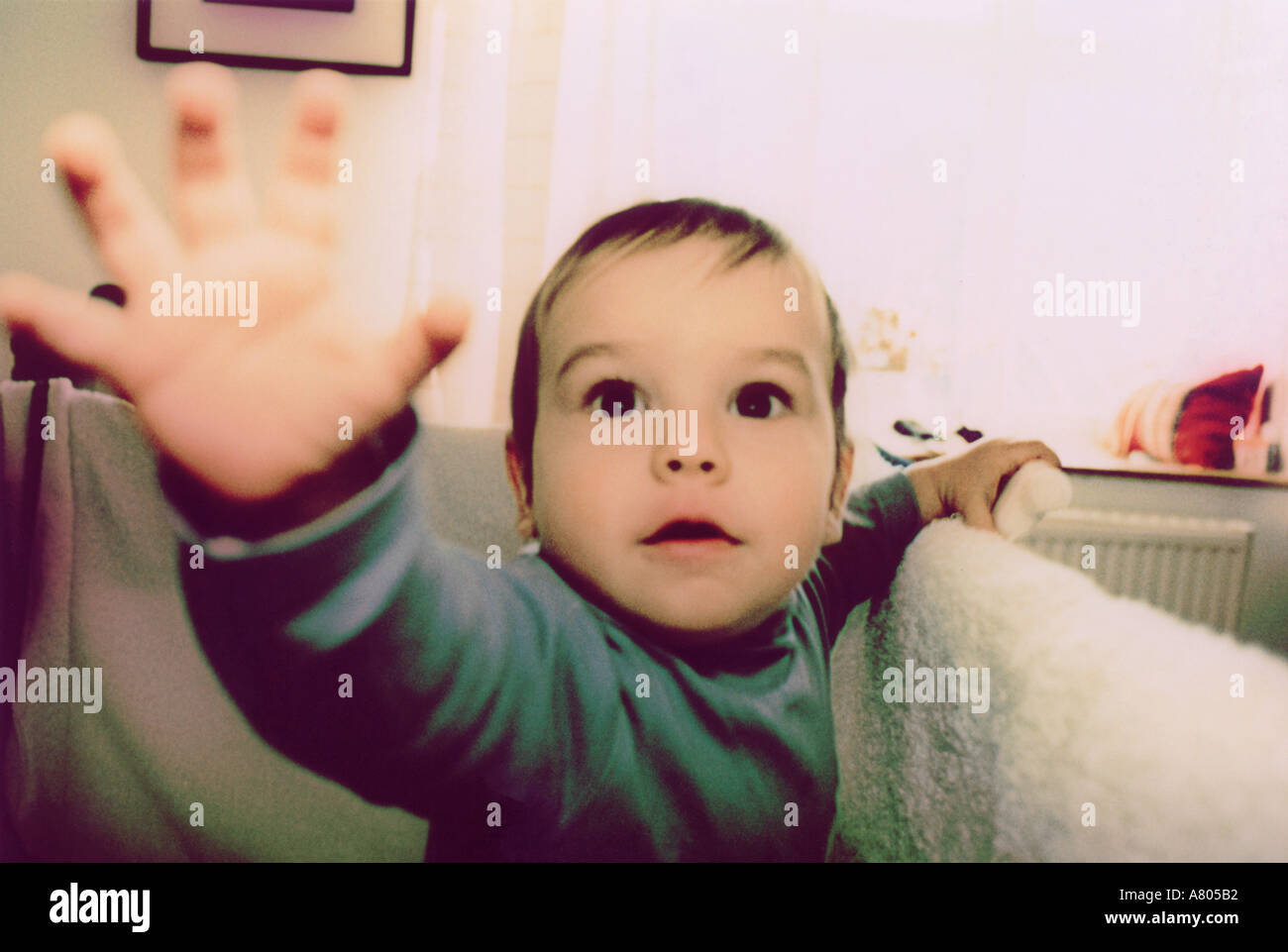 little boy reaching to his parents Stock Photo - Alamy