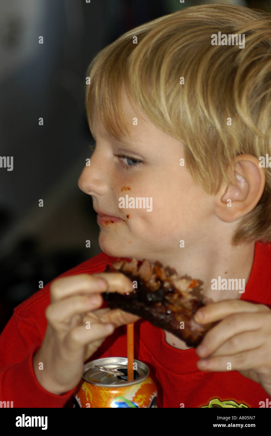 Summer humor young boy messy eater bbq barbecue Stock Photo - Alamy