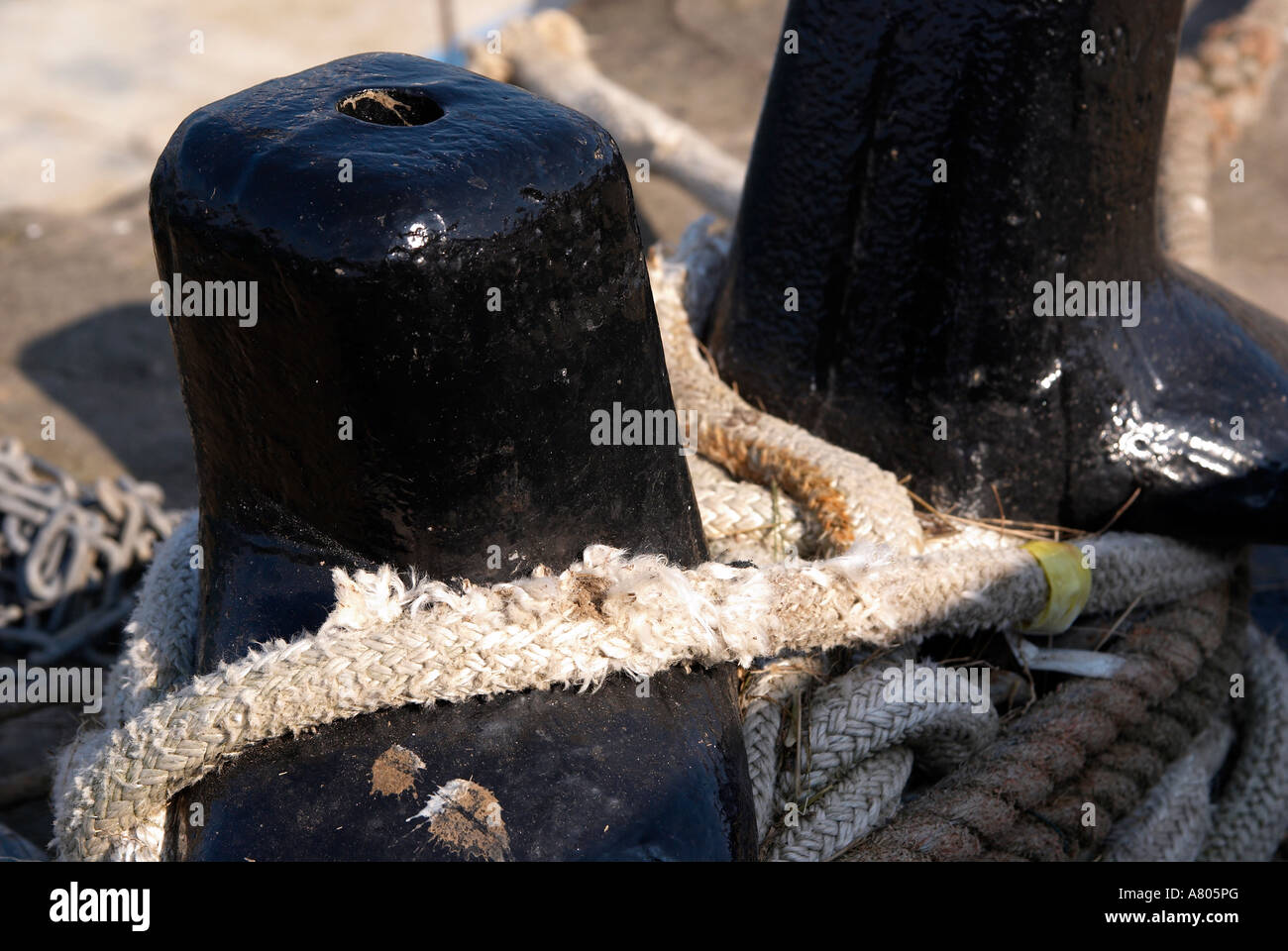 Mooring ropes tied to black bollards on the quayside at Wells-next-the ...