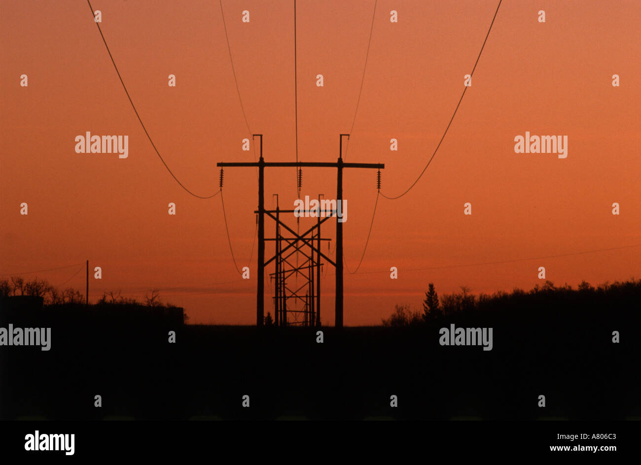 Electrical power lines at sunset Stock Photo - Alamy