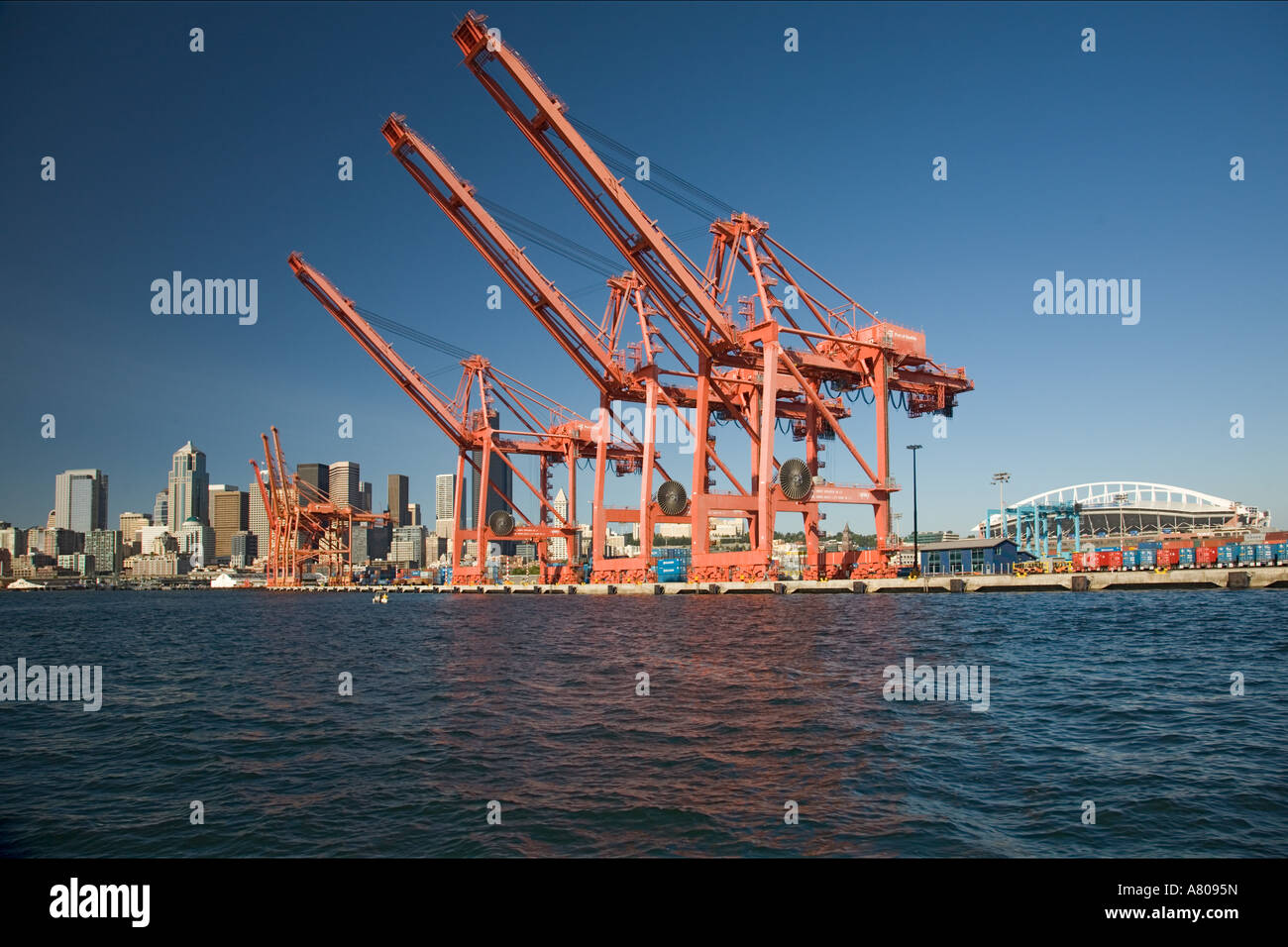 WA, Seattle, Seattle skyline with shipping cranes from Elliott Bay ...