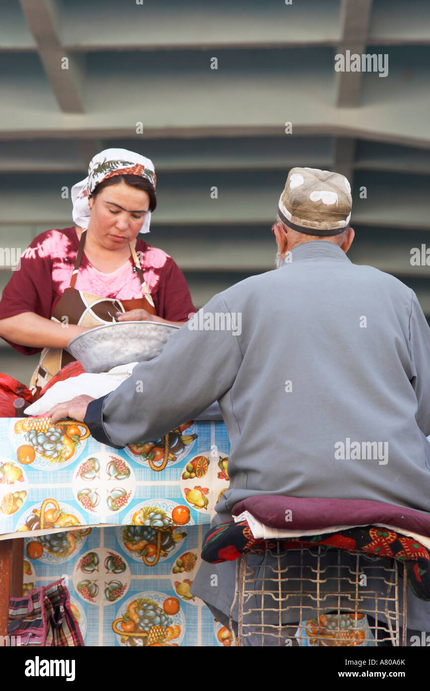 Uzbek Vendor And Customer At Samarkand Market Stock Photo - Alamy