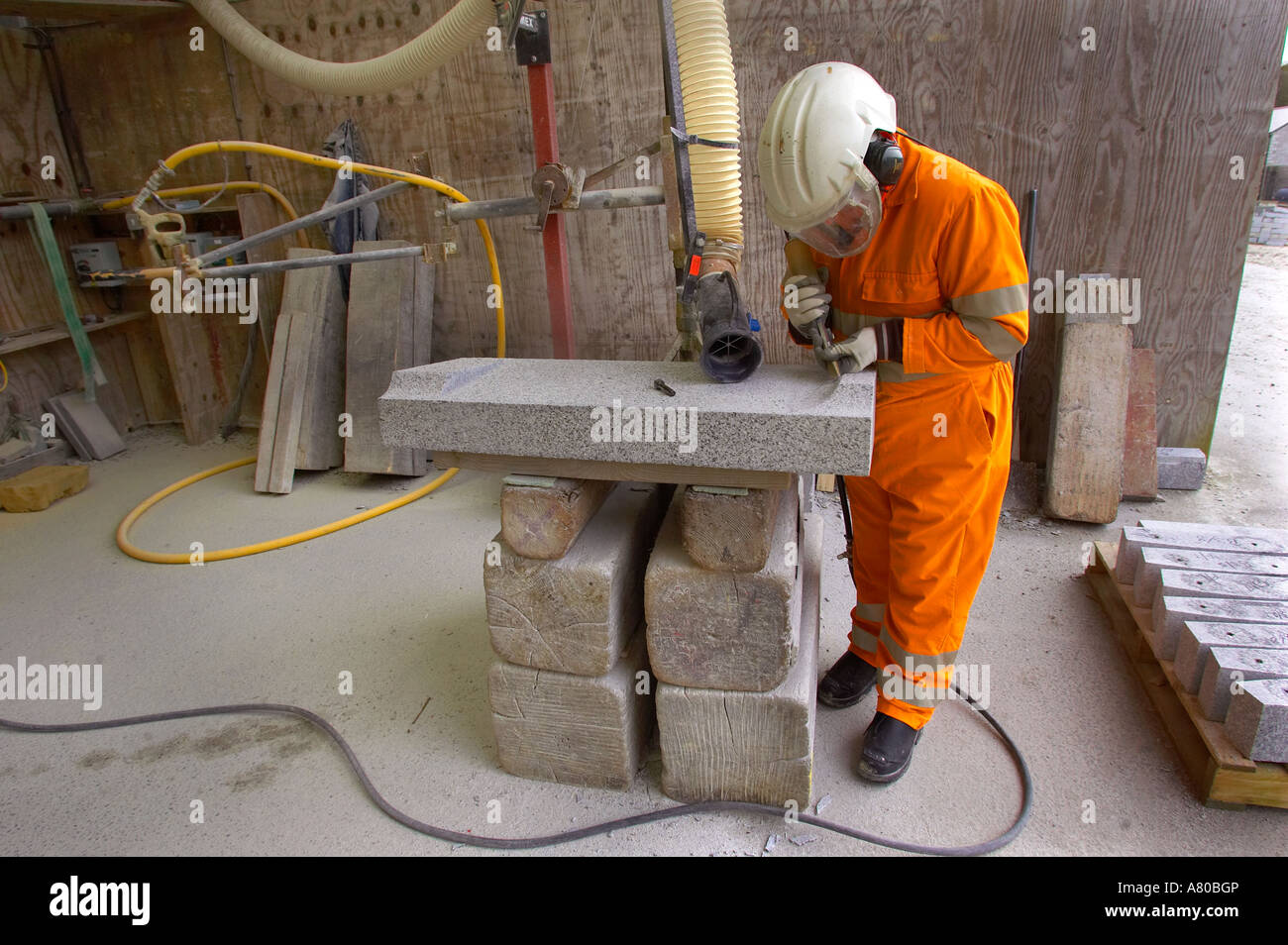Granite being carved at De Lank Quarry on Bodmin Moor in Cornwall, UK ...