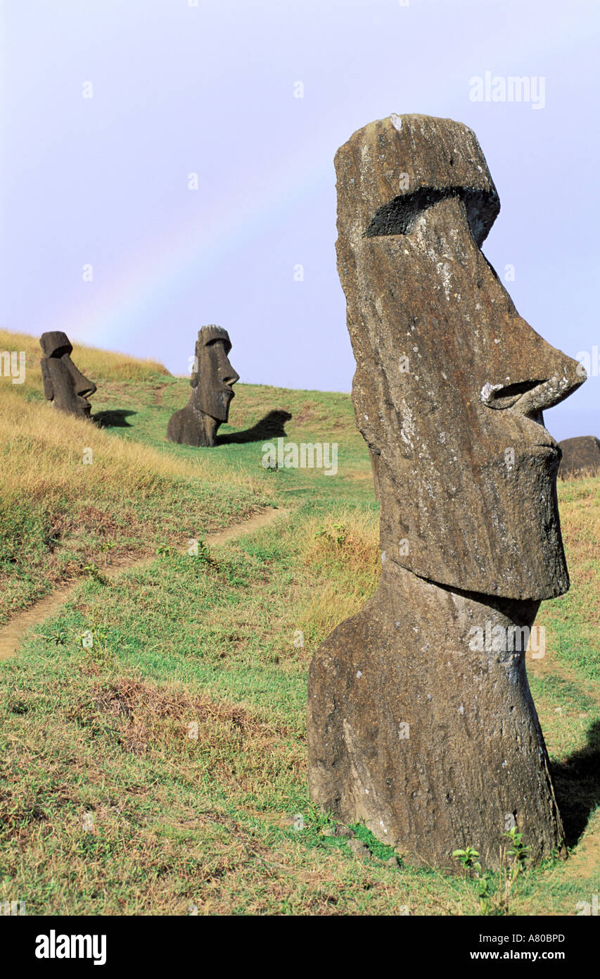Chile, Easter Island, rainbow and Moai statues carved out of big rocks ...