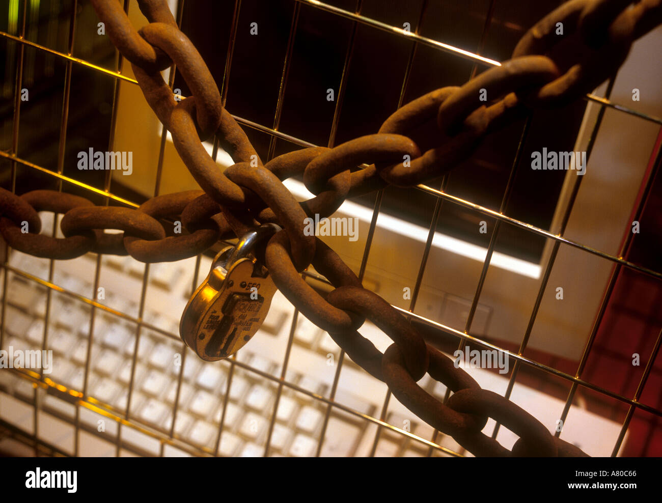 Computer secured by chains and padlock inside a metal cage Stock Photo ...