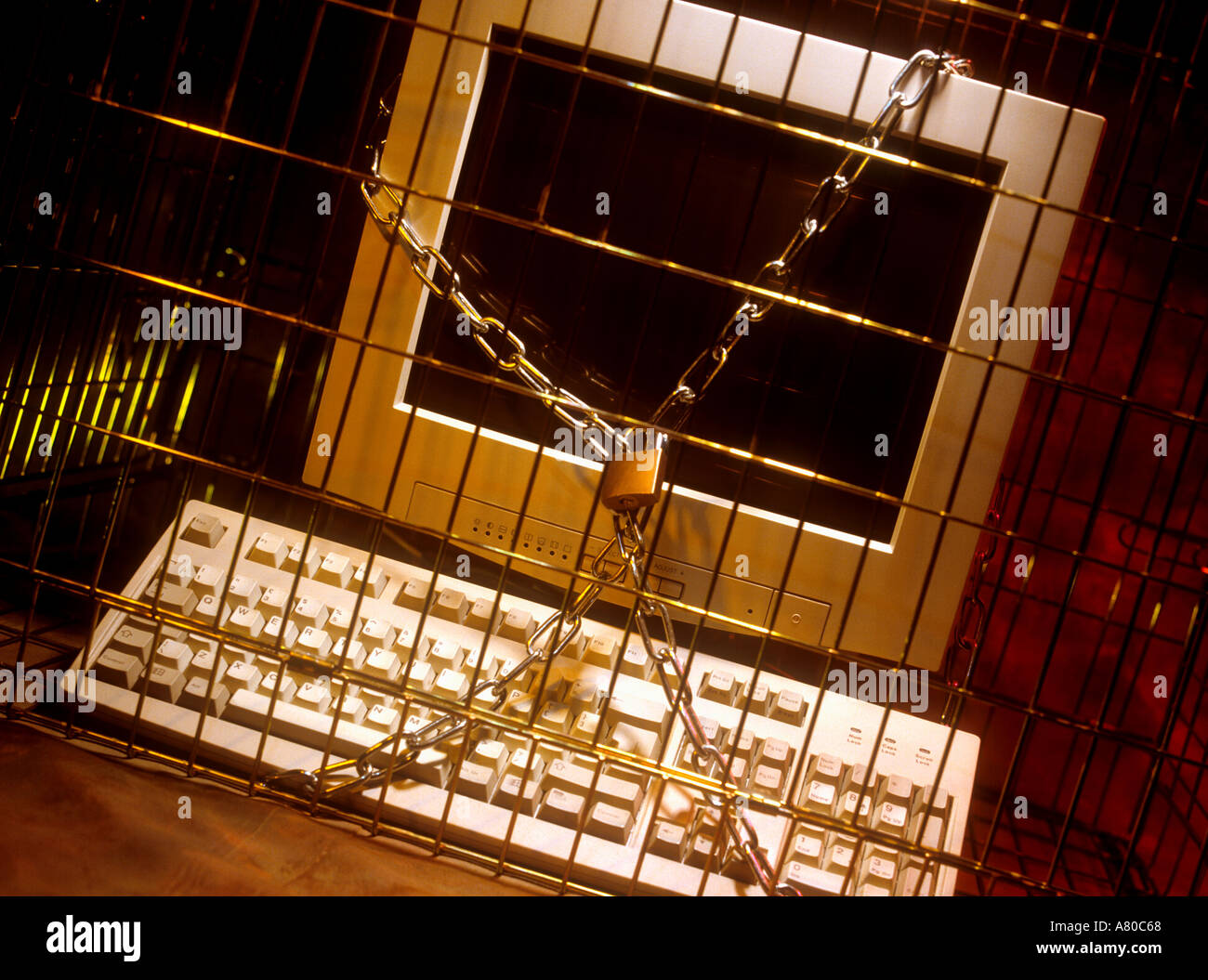 Computer secured by chains and padlock inside a metal cage Stock Photo ...