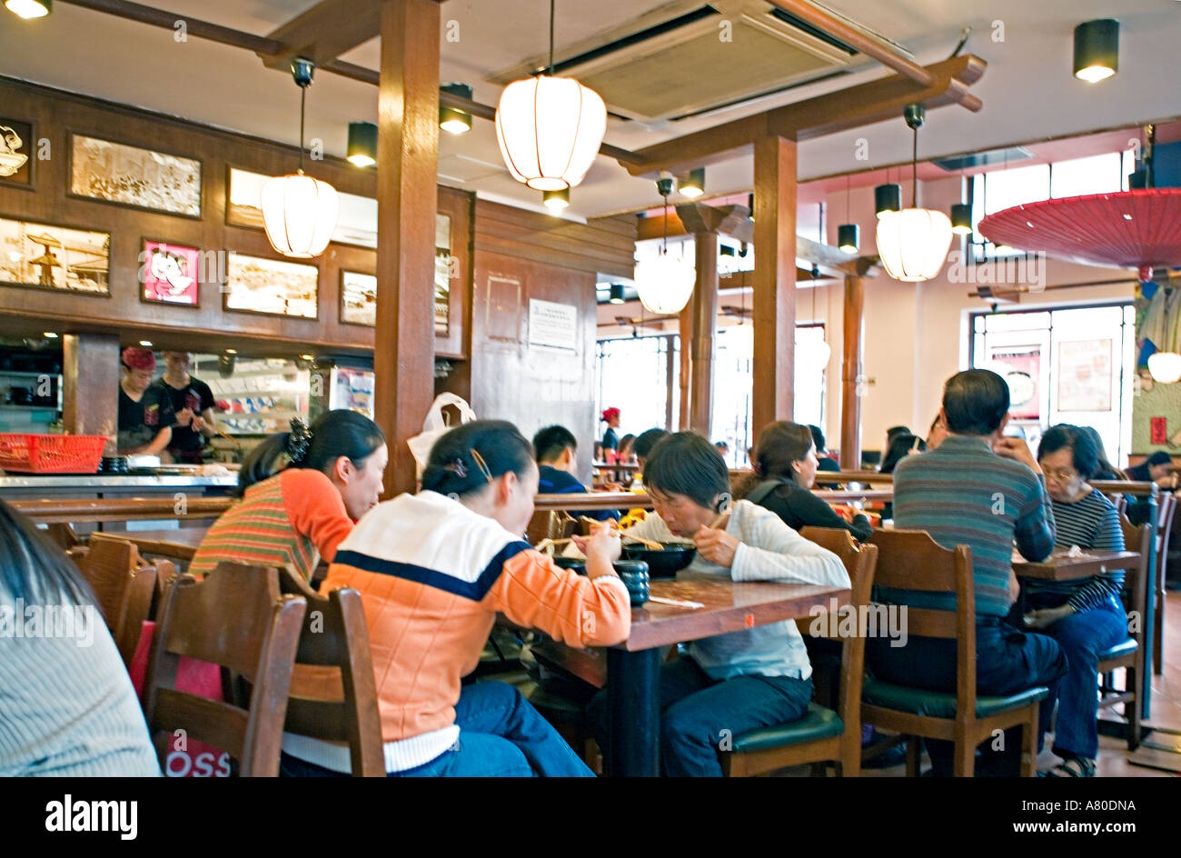 CHINA SHANGHAI Chinese diners enjoying lunch of noodle bowls served in ...