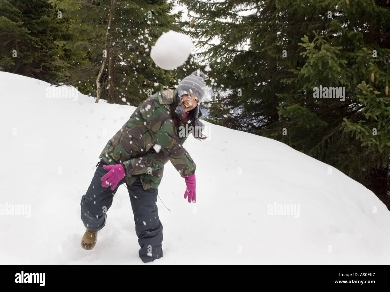 Girl Throwing a Snowball Stock Photo - Alamy