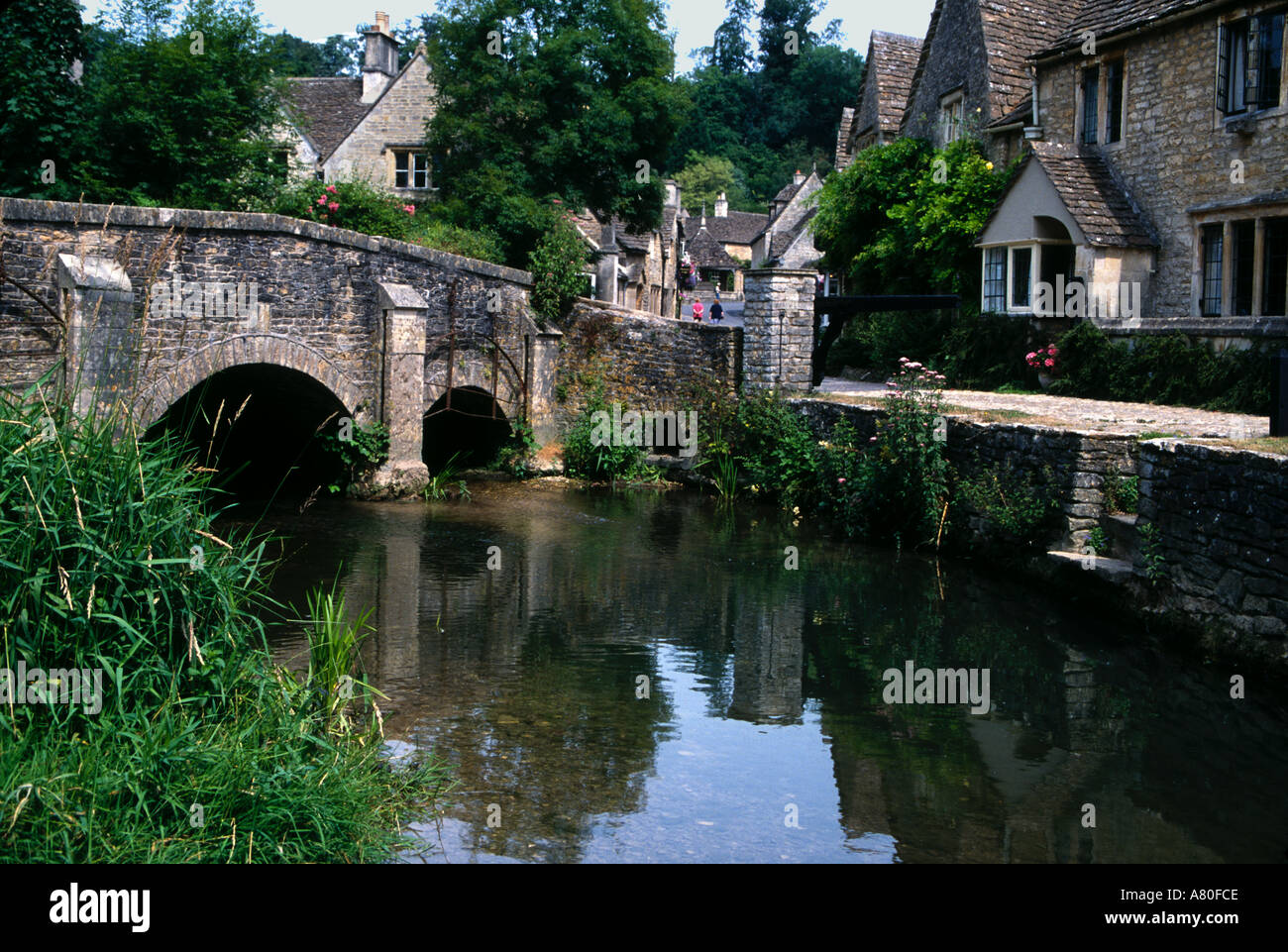 Stream and stone bridge Castle Coombe England Stock Photo - Alamy