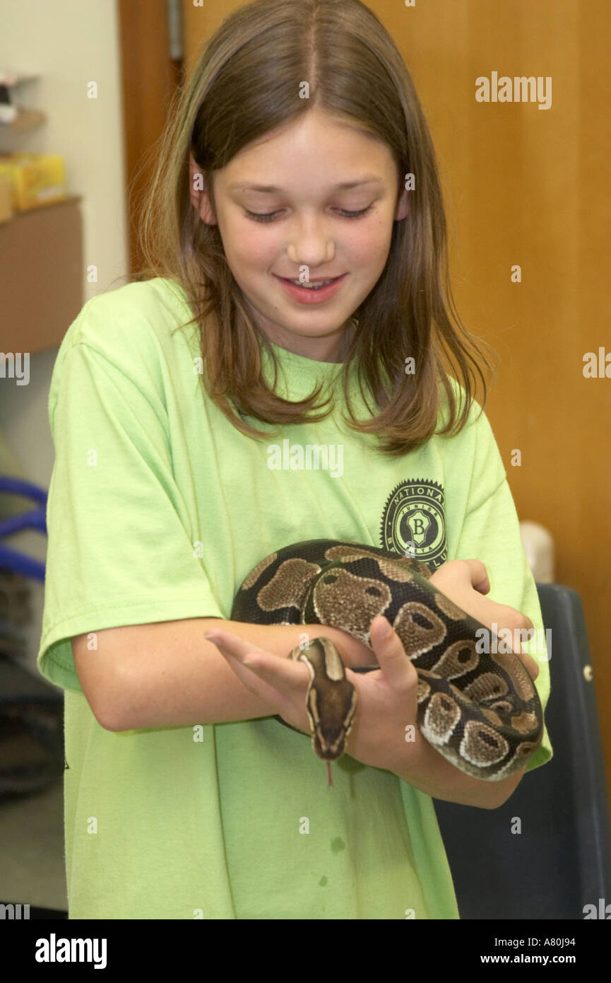 Young girl with a ball python at a reptile show Stock Photo - Alamy