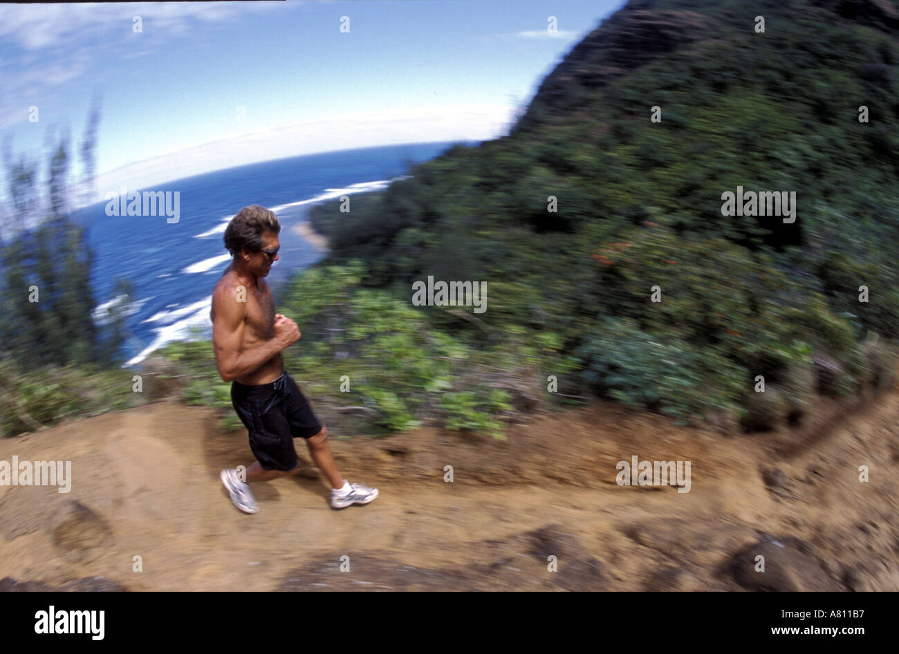 Hawaii Kauai Na Pali coast trail trail runner Stock Photo - Alamy