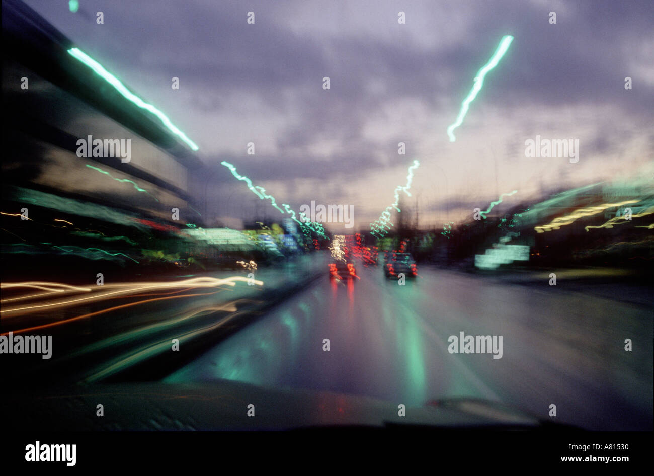 slow shutter speed image of light street traffic through windshield on ...