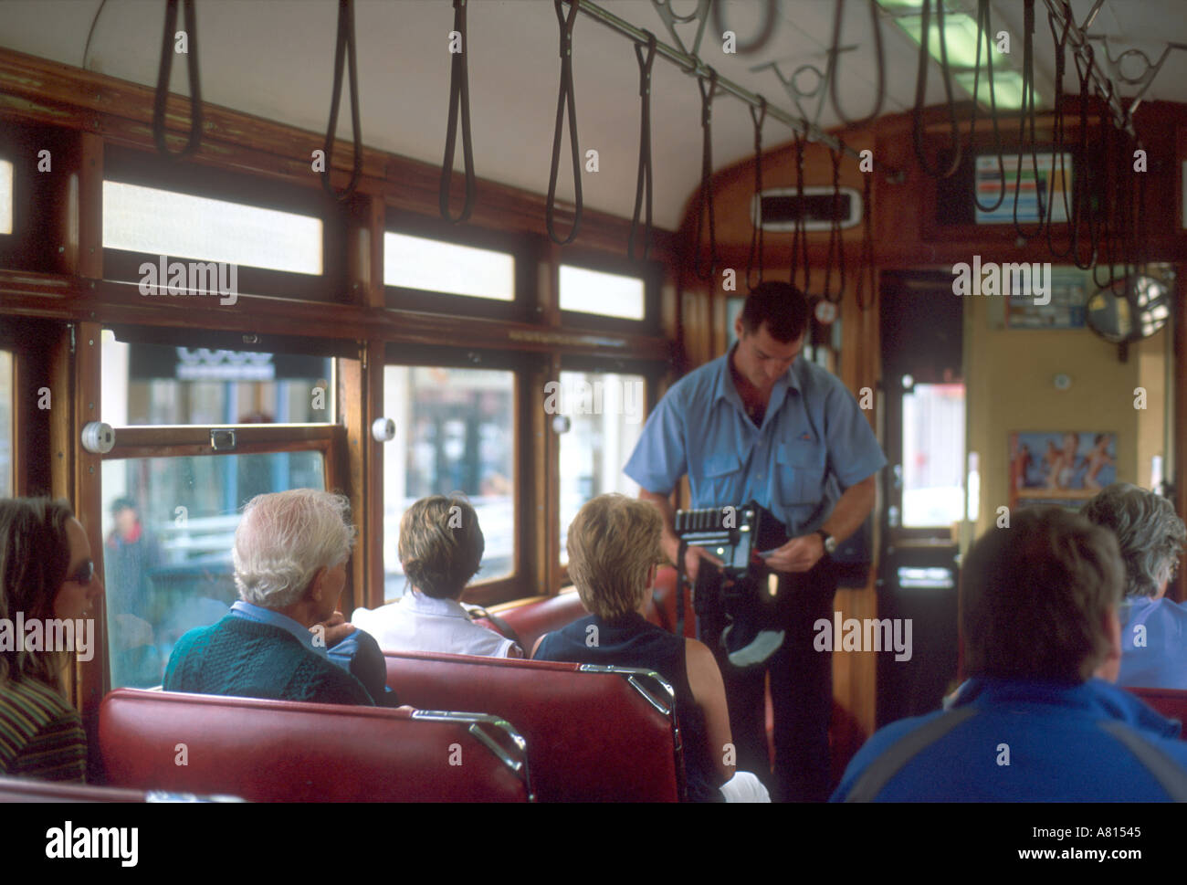 CONDUCTOR TAKING FARES ON THE GLENELG TRAM ADELAIDE SOUTH AUSTRALIA ...