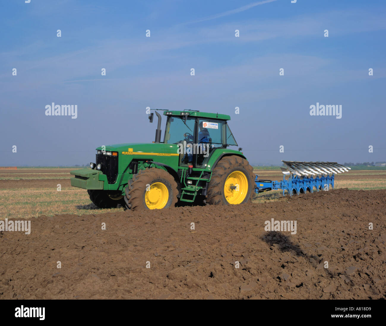 John Deere 8400 tractor with eight furrow reversible plough (State of ...