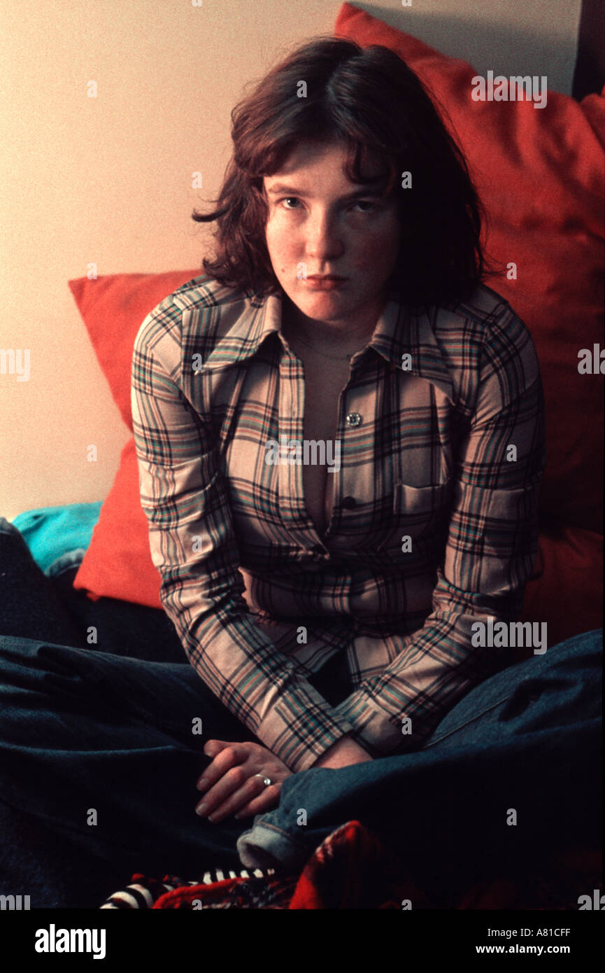Portrait of a young woman with dark red hair check shirt and a pouty ...