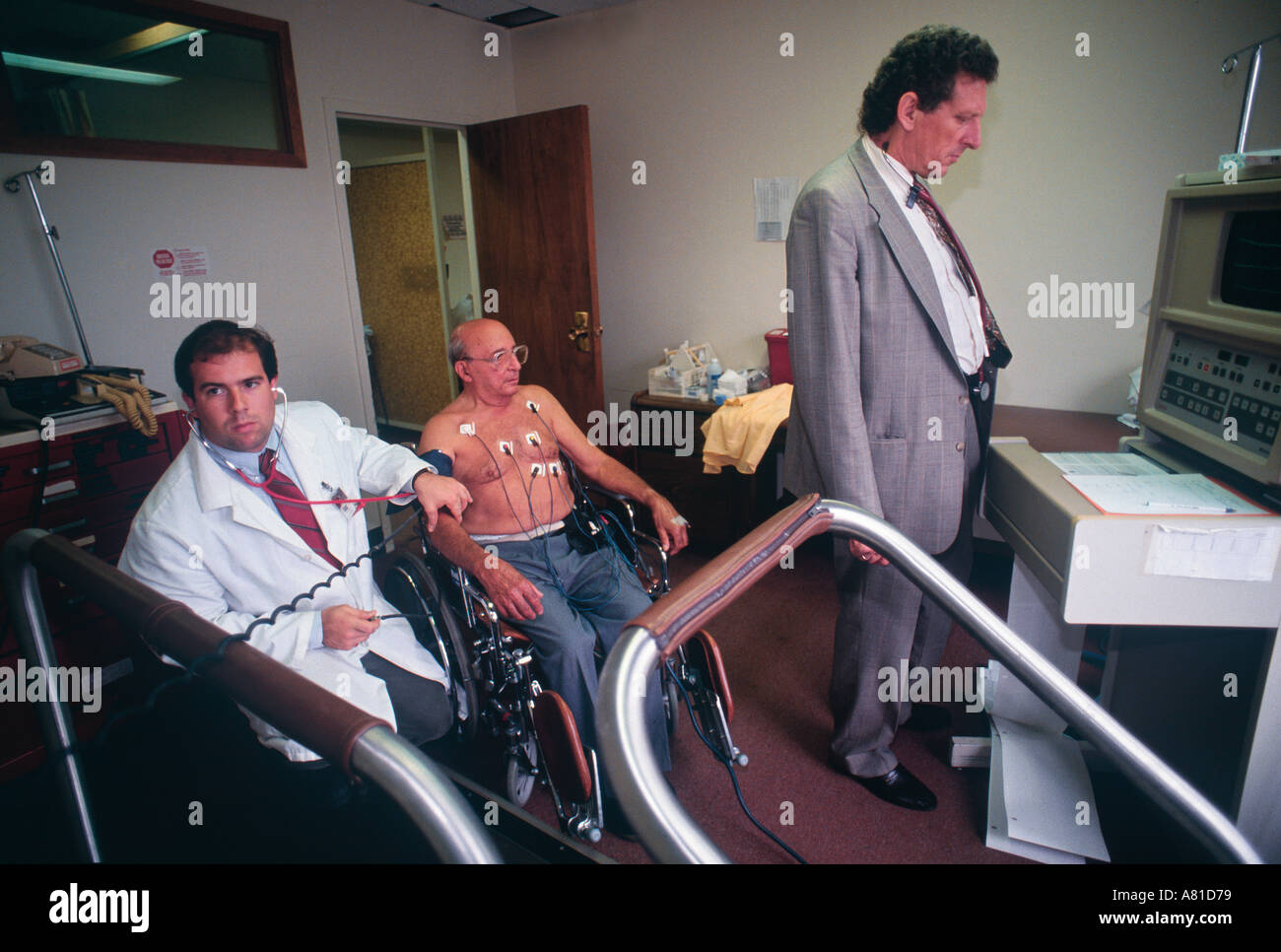 elderly man is monitored after a Thalium stress test by two doctors ...