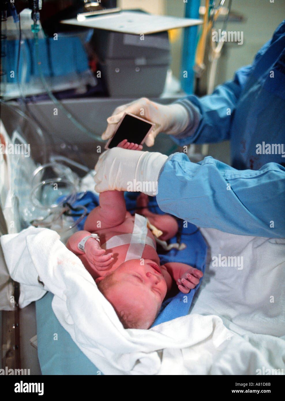 child birth new born foot print for saftey and identification by gloved ...